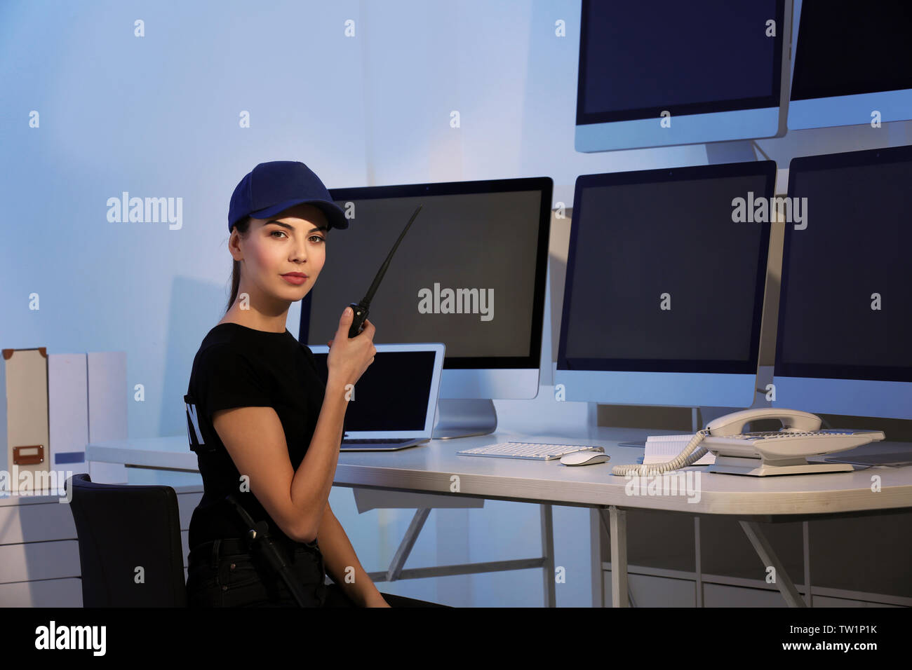 Beautiful security guard in surveillance room Stock Photo - Alamy