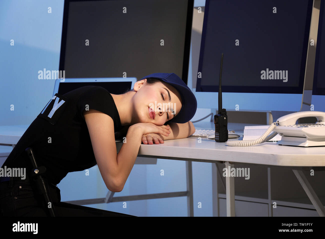 Beautiful security guard sleeping in surveillance room Stock Photo - Alamy