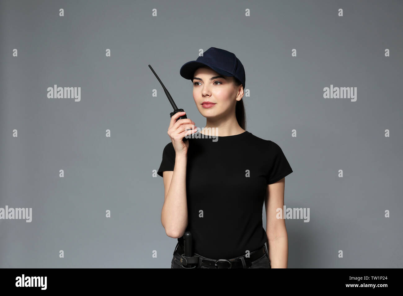 Beautiful young woman in security uniform on grey background Stock ...