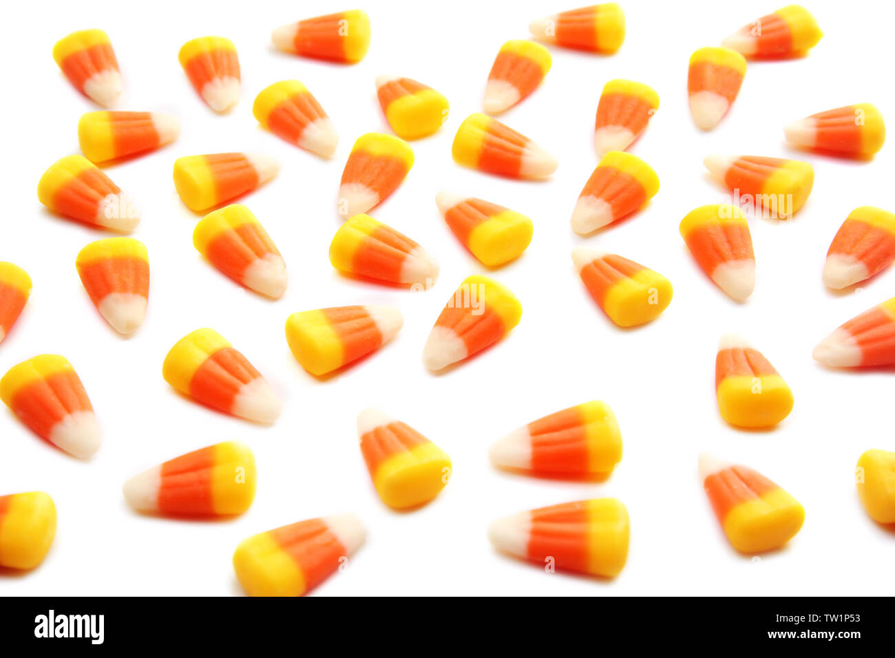 Colorful Halloween candy corns on white background Stock Photo - Alamy