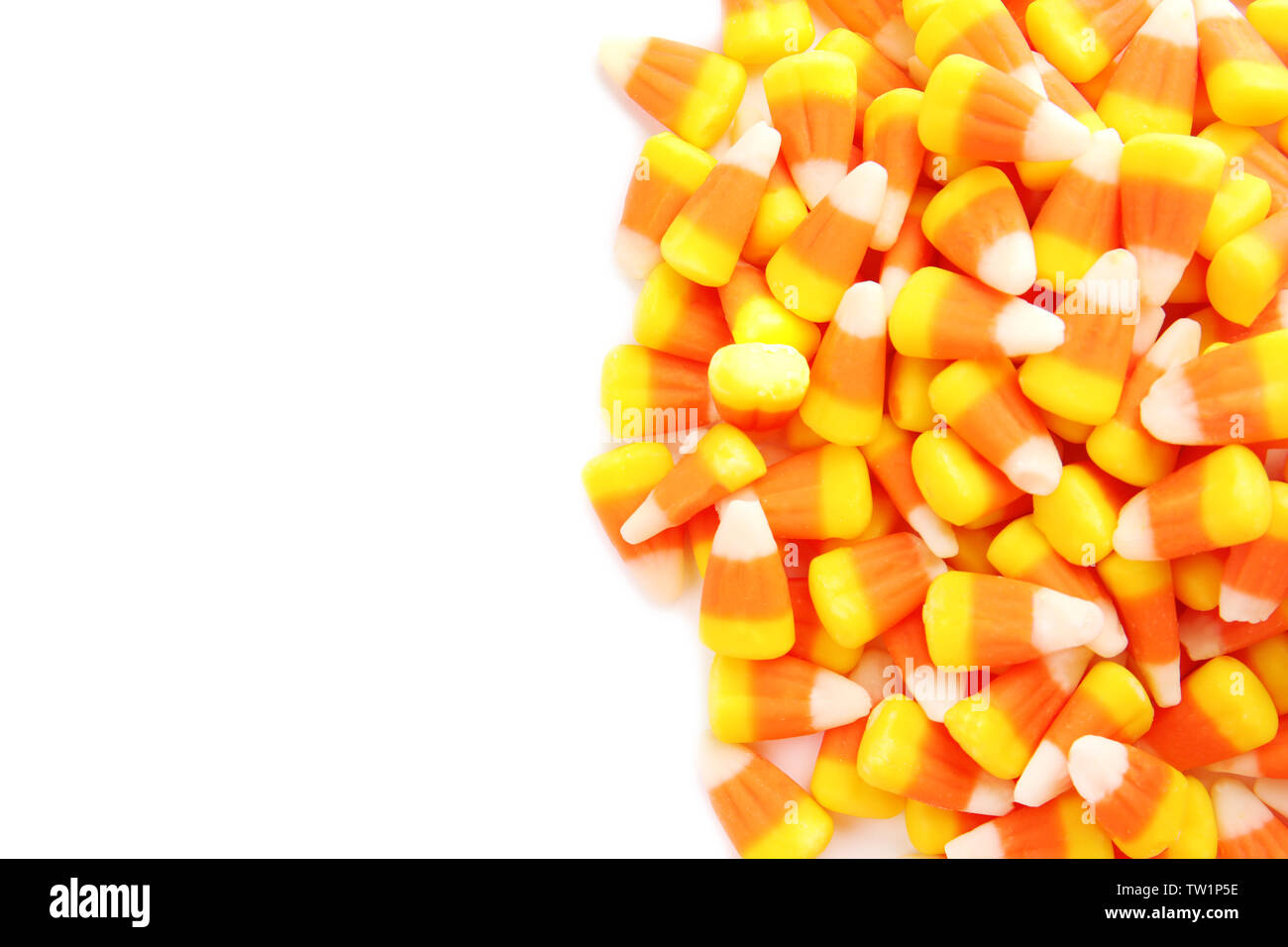 Colorful Halloween candy corns on white background Stock Photo - Alamy