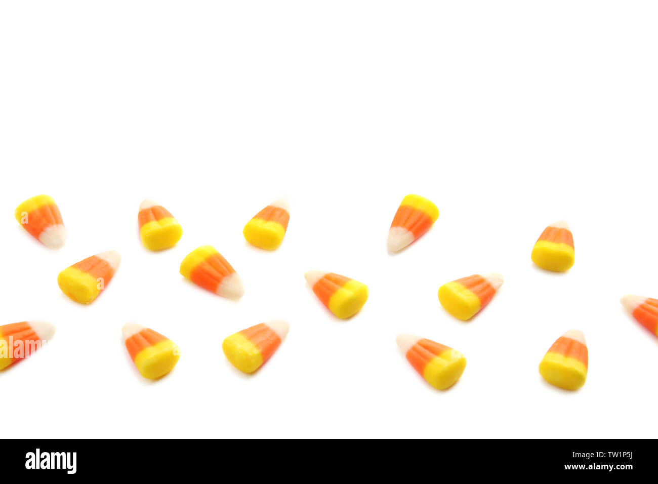 Colorful Halloween candy corns on white background Stock Photo - Alamy