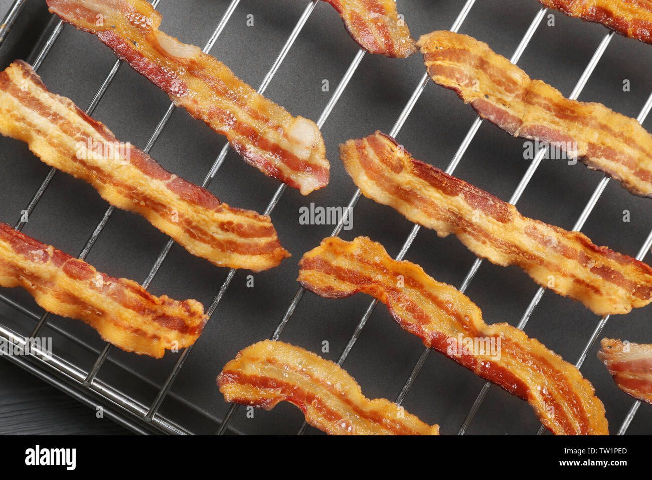 Baking tray with strips of fried bacon, closeup Stock Photo - Alamy
