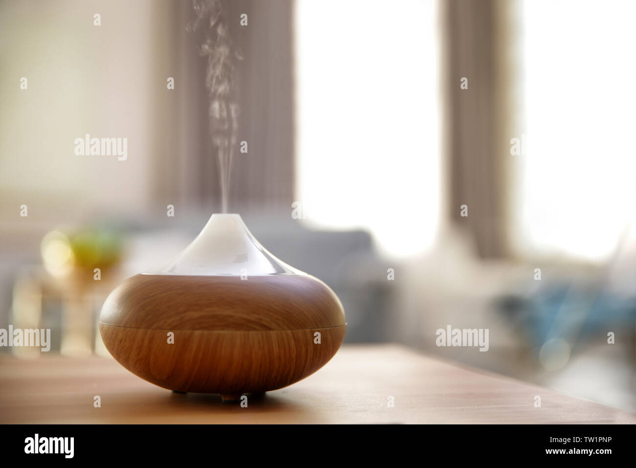 Electric oil diffuser on blurred room background Stock Photo - Alamy