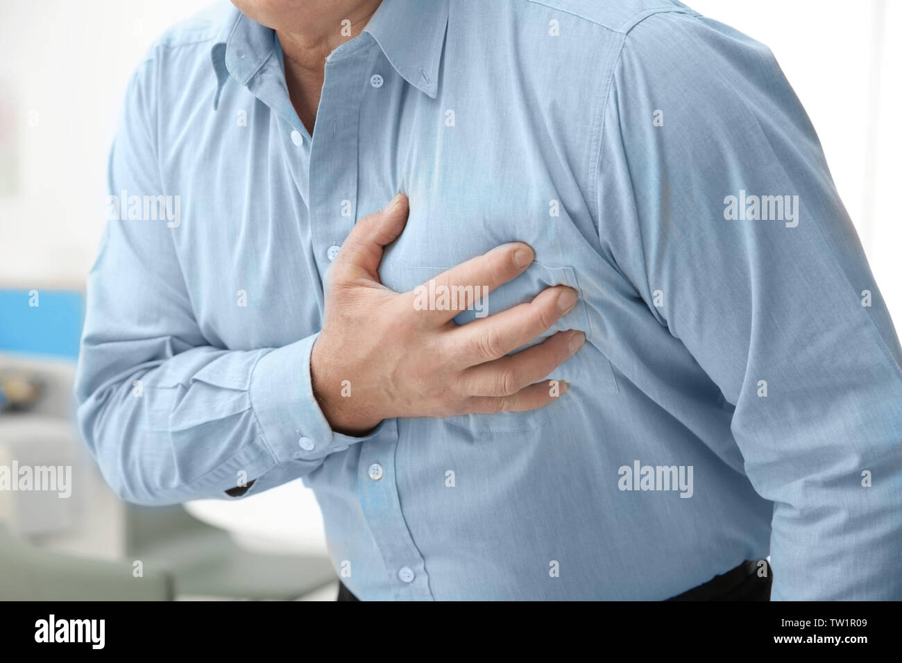 Man with chest pain suffering from heart attack in office Stock Photo ...