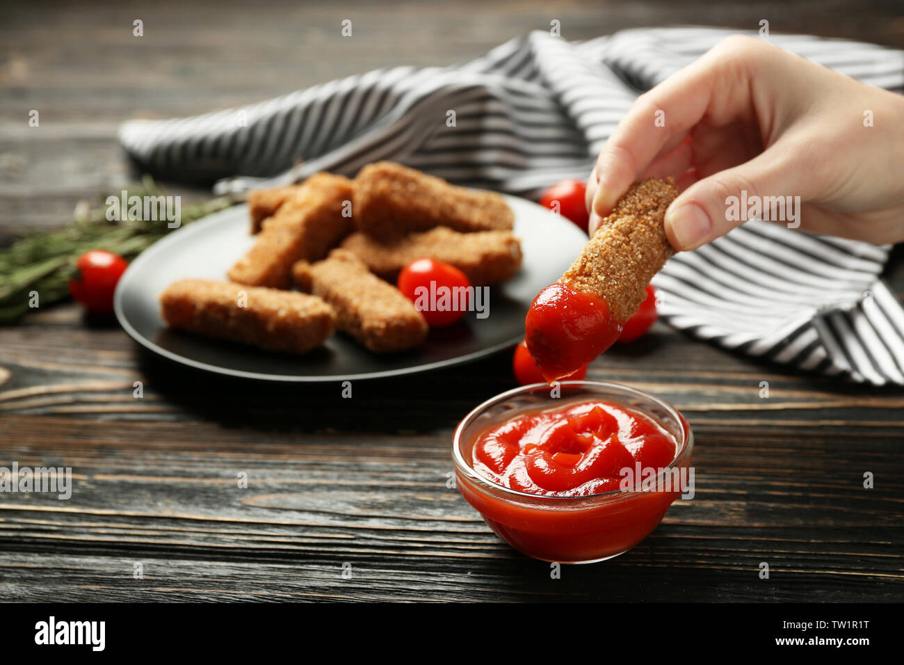 Female hand holding cheese stick with ketchup, closeup Stock Photo - Alamy