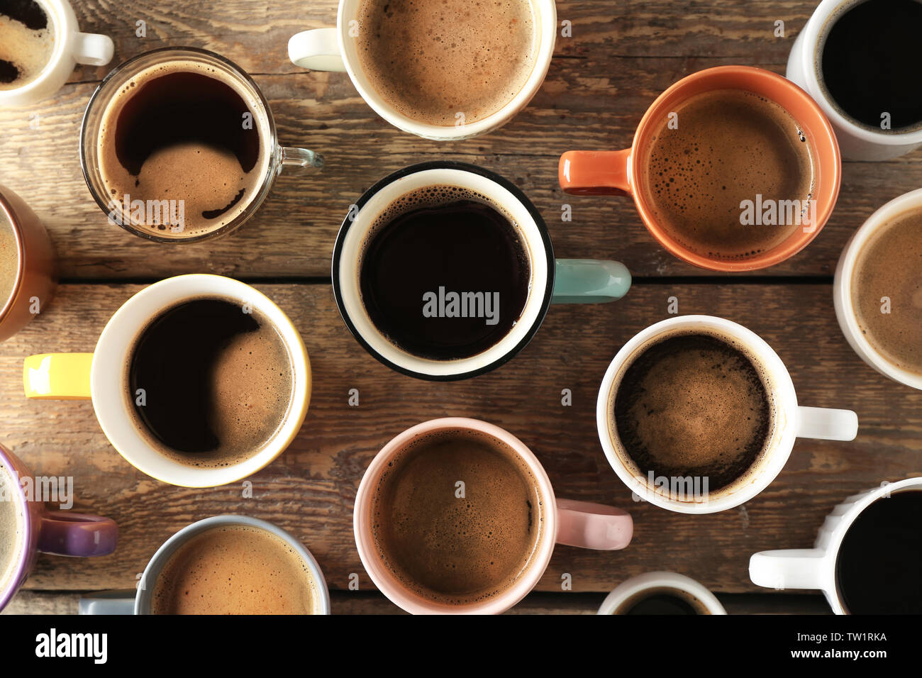 Lots of coffee cups on wooden background Stock Photo - Alamy