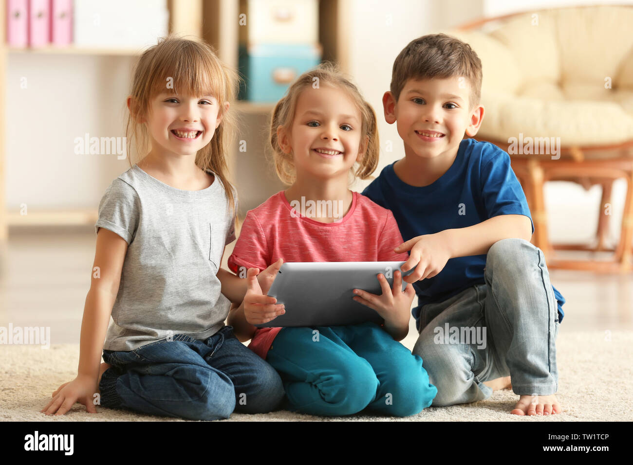 Cute kids using digital tablet Stock Photo - Alamy