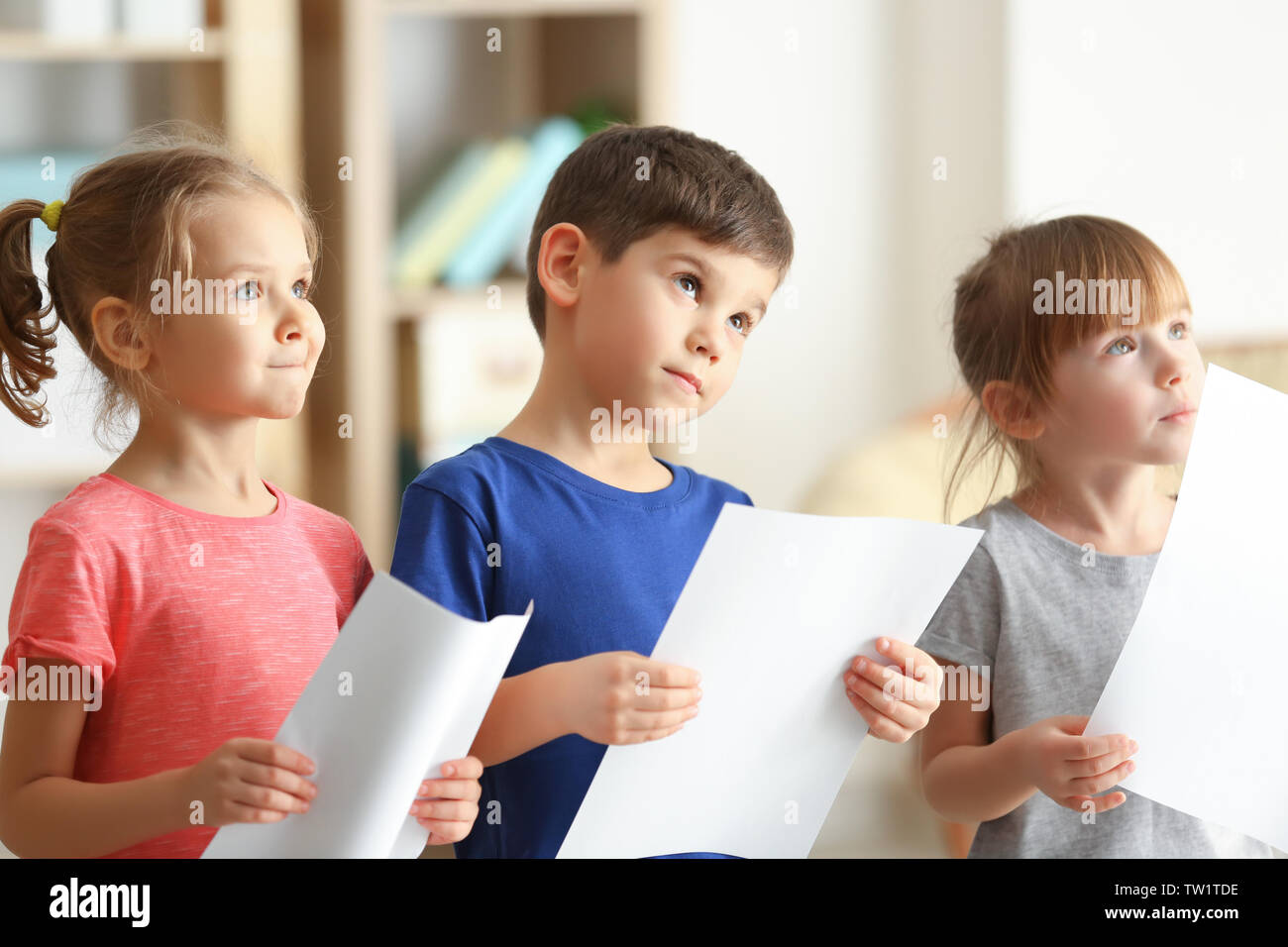 Cute kids singing in music class Stock Photo - Alamy