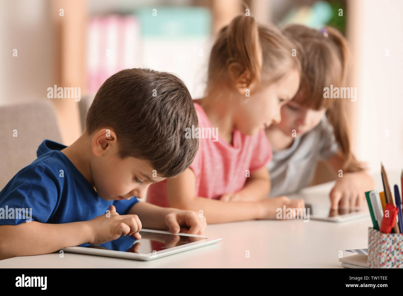 Cute kids using digital gadgets Stock Photo - Alamy