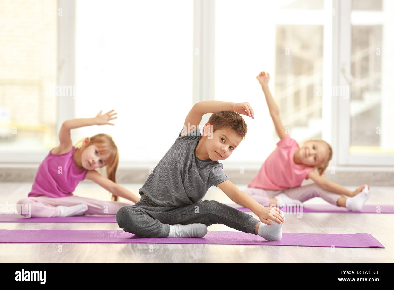 Group of children doing gymnastic exercises Stock Photo - Alamy