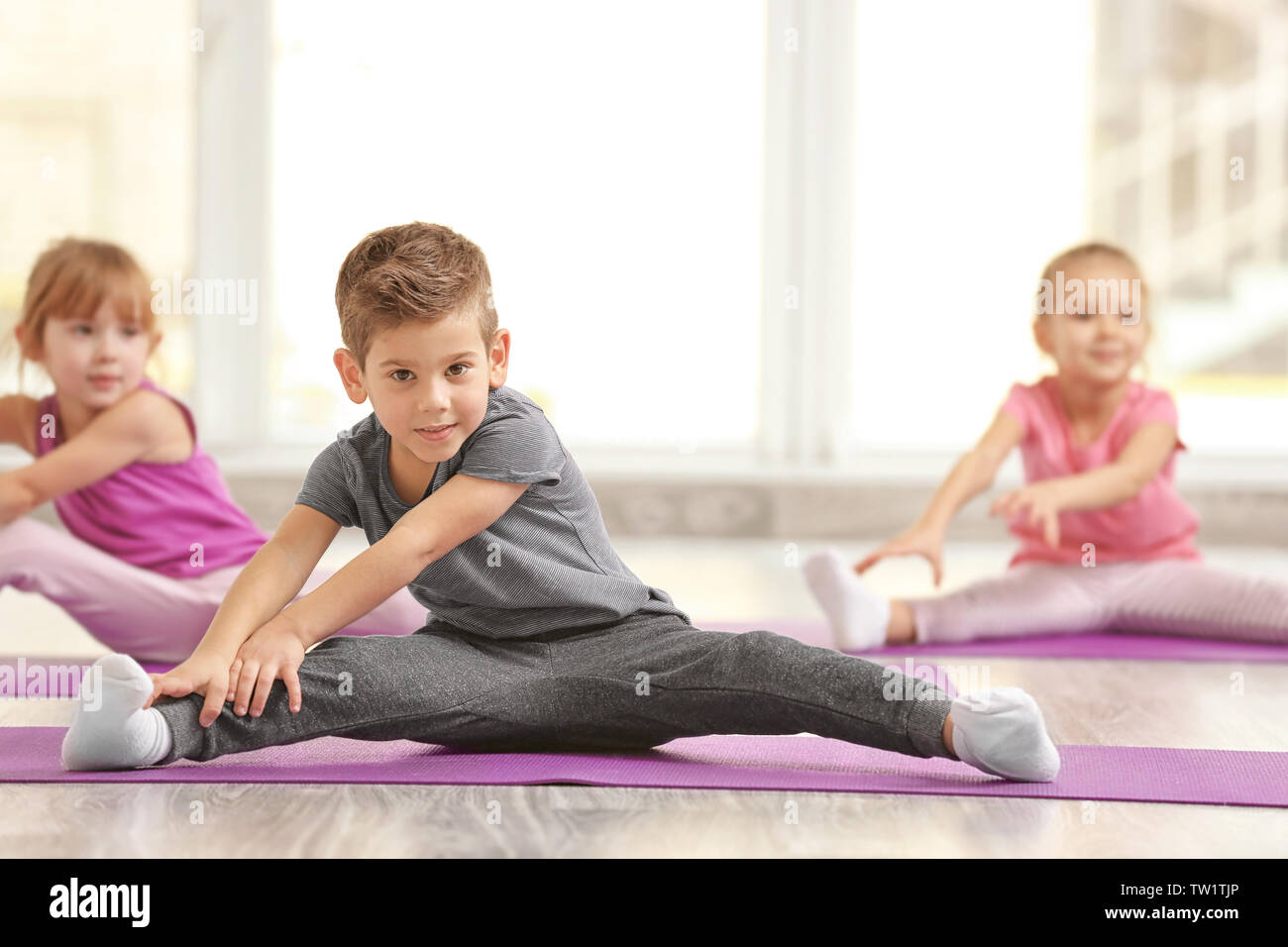 Group of children doing gymnastic exercises Stock Photo - Alamy