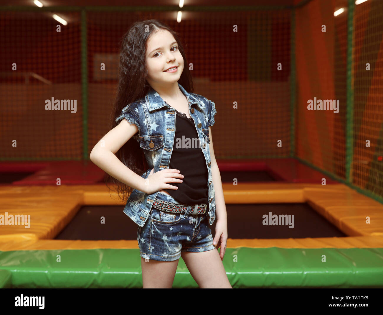 Cute girl playing on trampoline Stock Photo - Alamy
