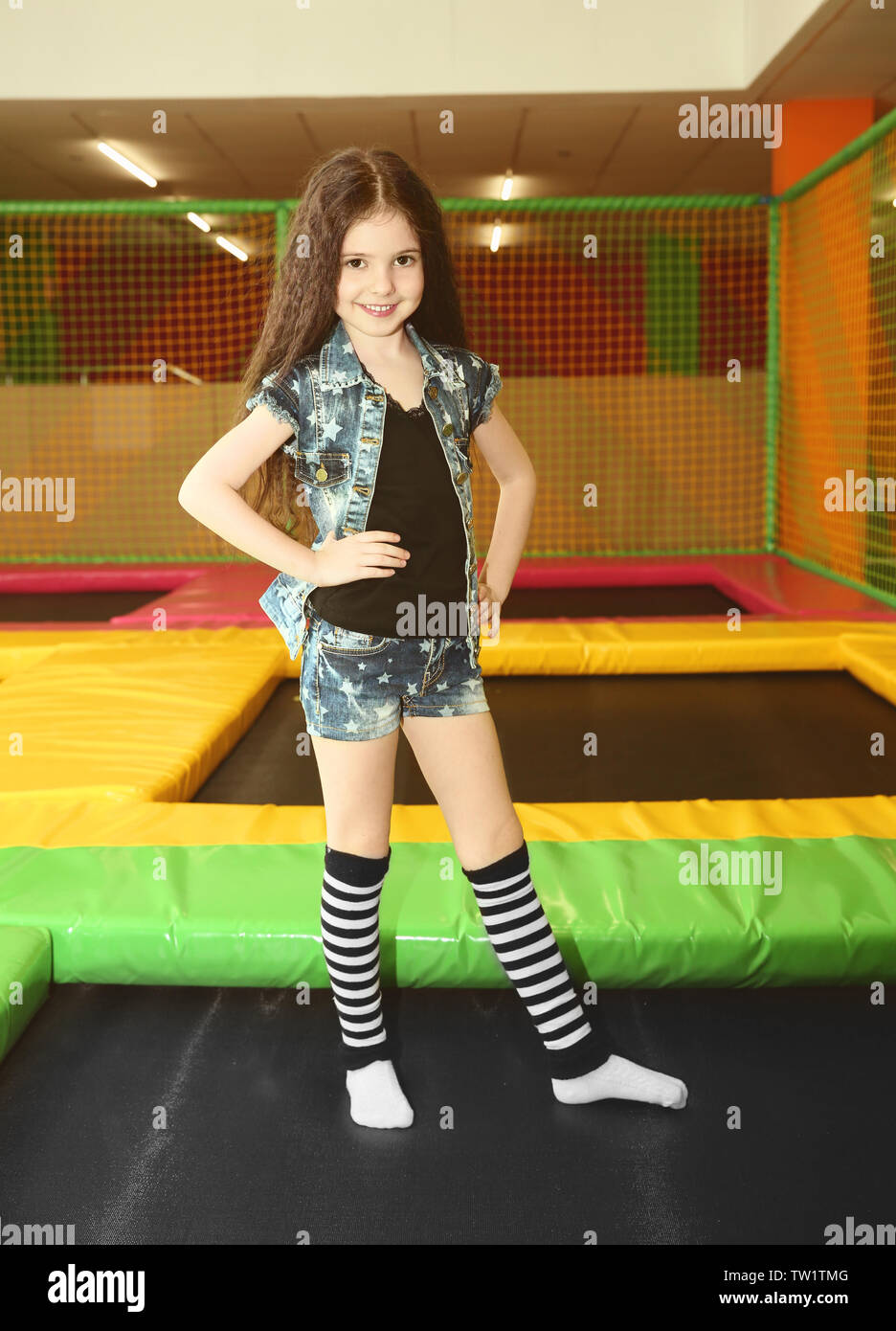 Cute girl playing on trampoline Stock Photo - Alamy