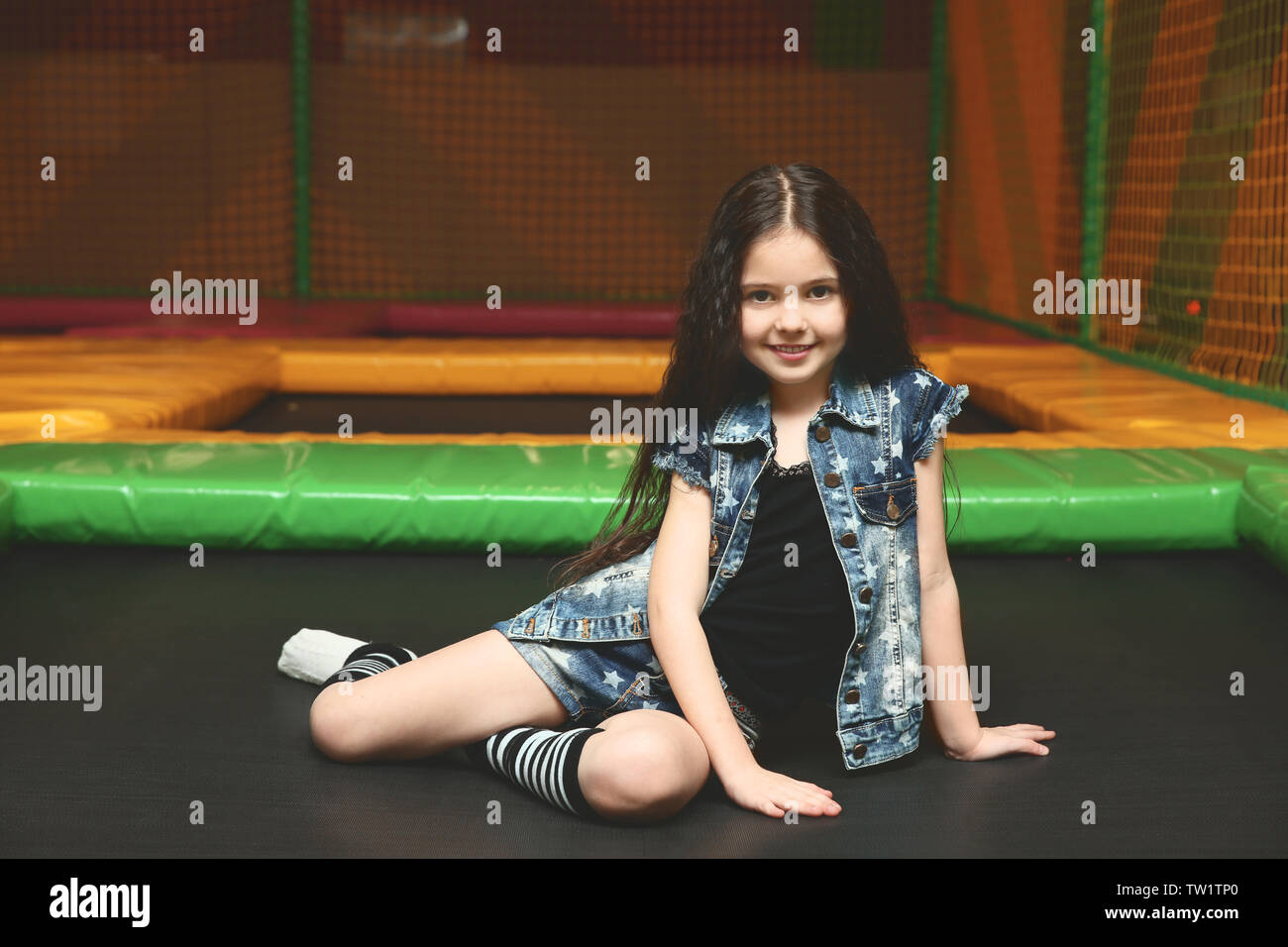 Cute girl playing on trampoline Stock Photo - Alamy