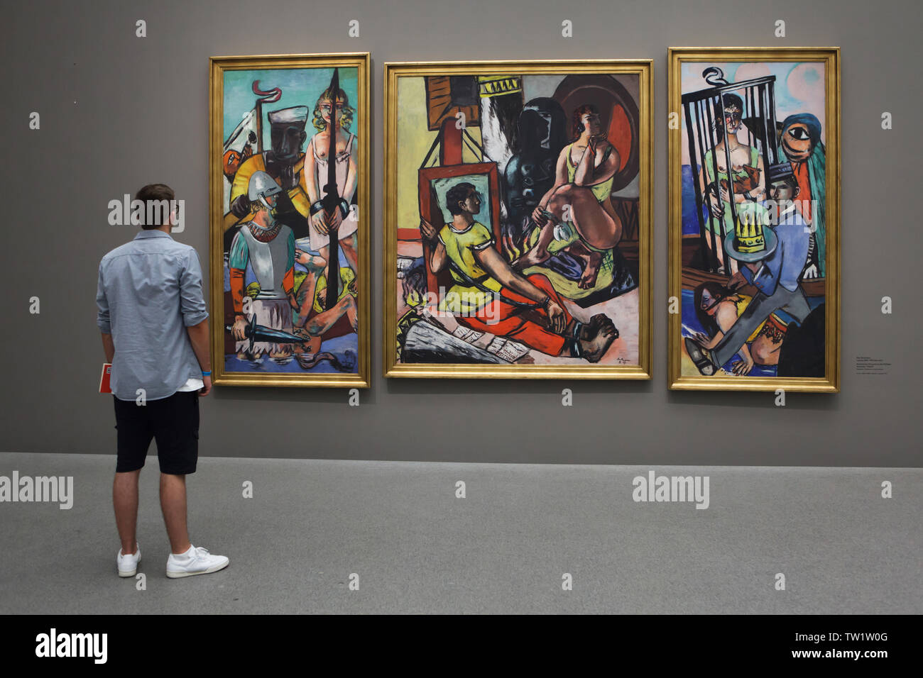 Visitor in front of the triptych 'Temptation of Saint Anthony ...