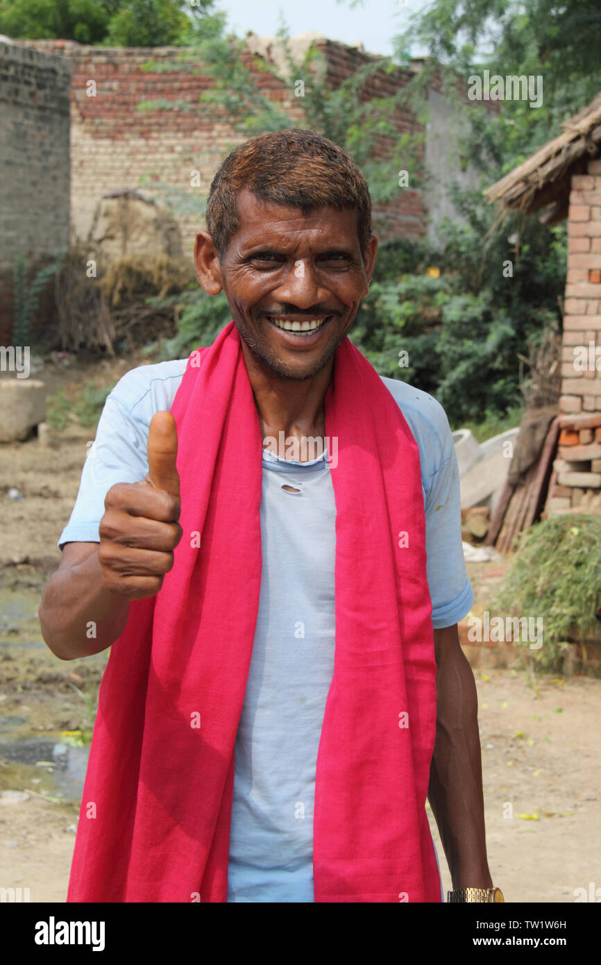 Portrait of a man showing thumbs up and smiling, India Stock Photo - Alamy