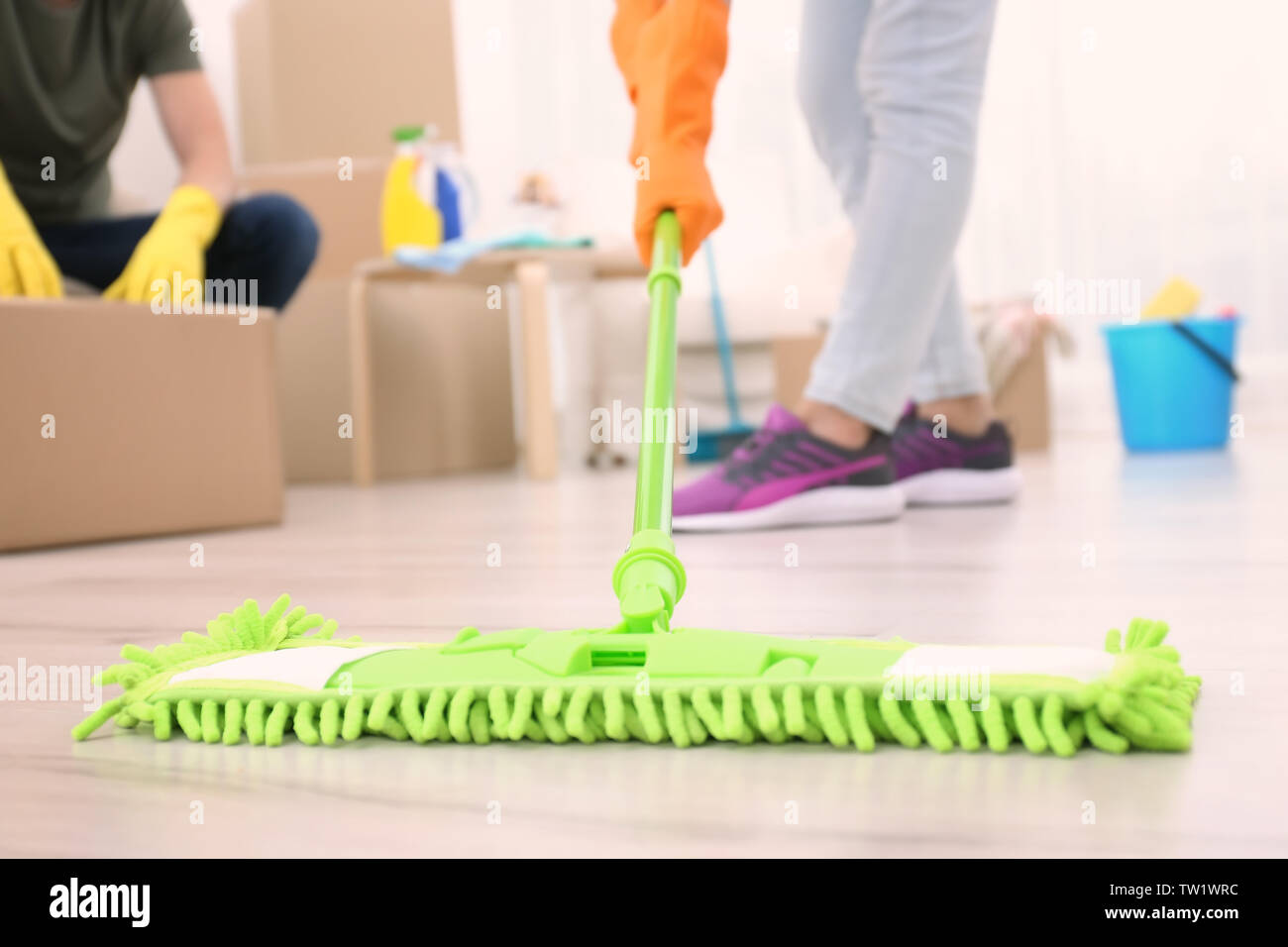 Woman moping the floor hi-res stock photography and images - Alamy