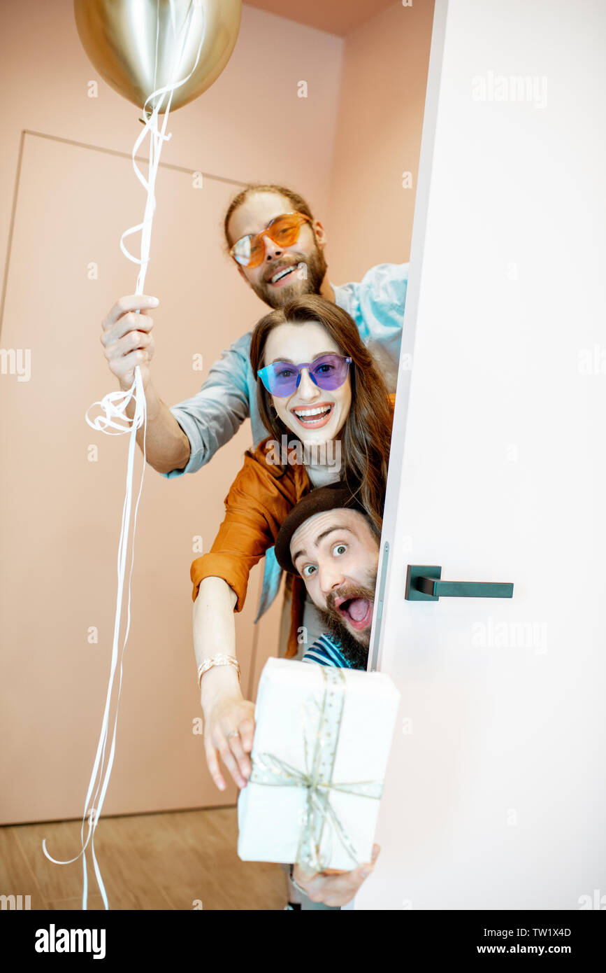 Friends coming home for the birthday celebration, looking out with ...