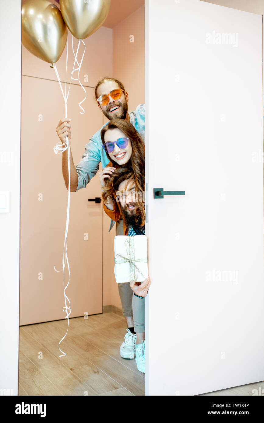 Friends coming home for the birthday celebration, looking out with ...