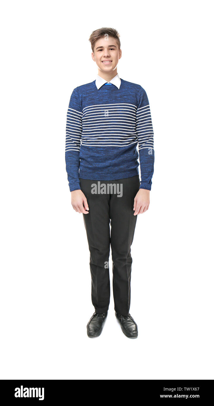 Cheerfully smiling school boy standing on light background Stock Photo ...