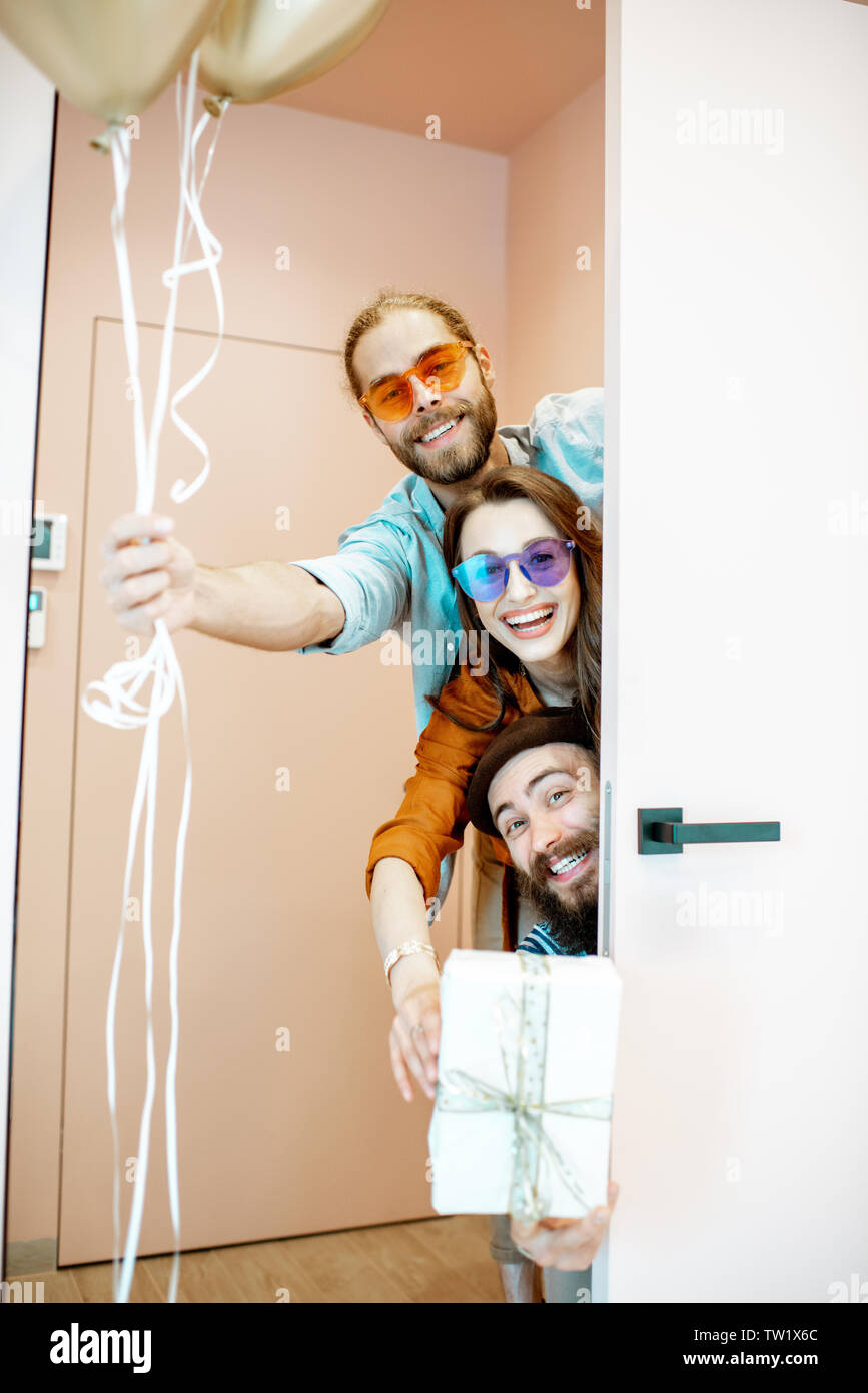 Friends coming home for the birthday celebration, looking out with ...