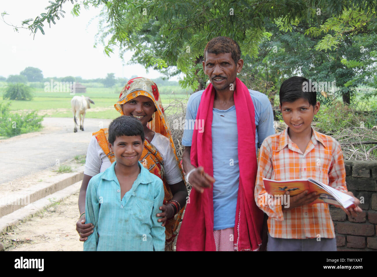 Rural family standing under a tree, India Stock Photo - Alamy