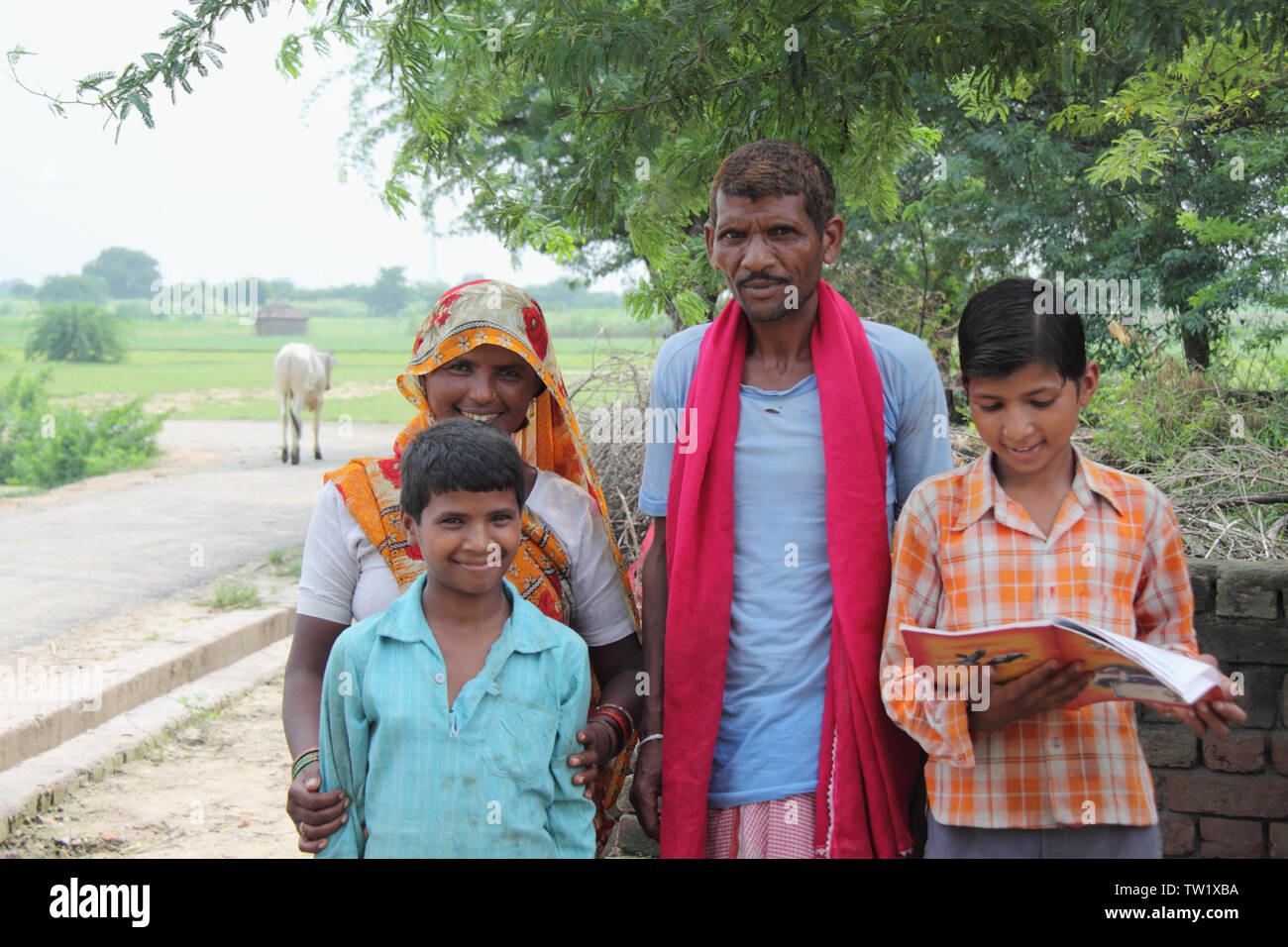 Rural family standing under a tree, India Stock Photo - Alamy