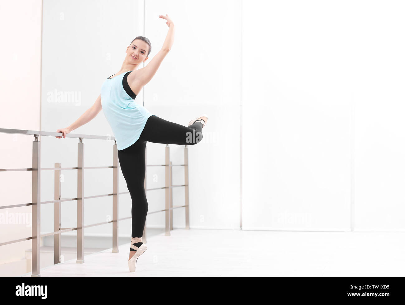 Ballet art concept. Young beautiful ballerina training in dance hall Stock Photo - Alamy