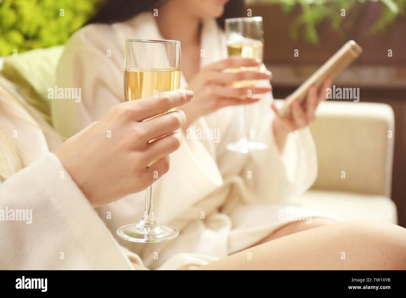 Young woman with glass of champagne resting in spa salon, closeup Stock ...