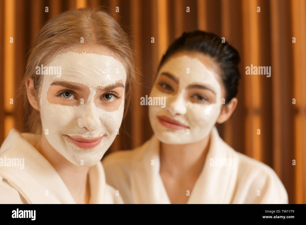 Beautiful young women with masks on faces resting in spa salon Stock ...
