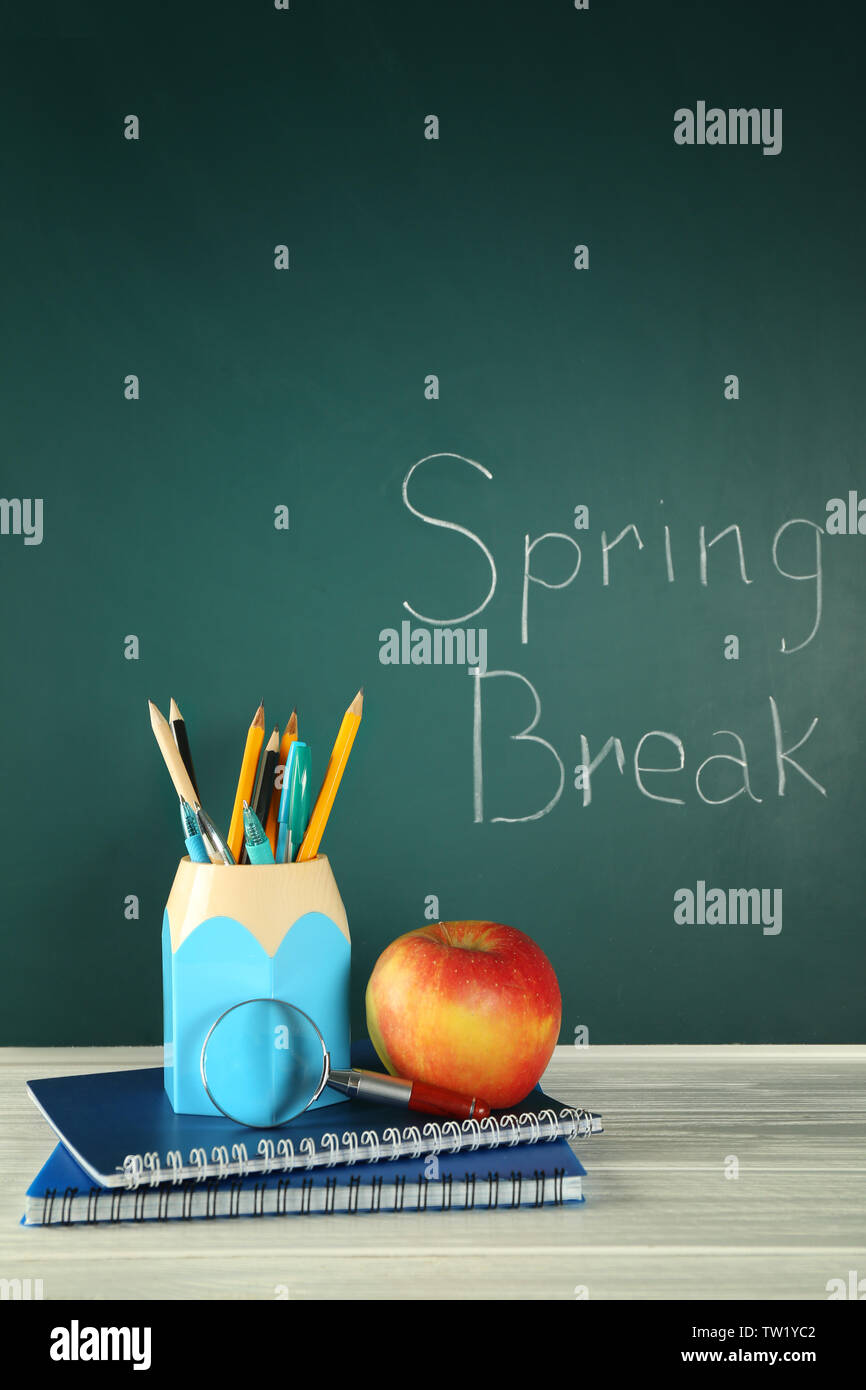 School stationery and "Spring break" text on chalkboard Stock Photo - Alamy