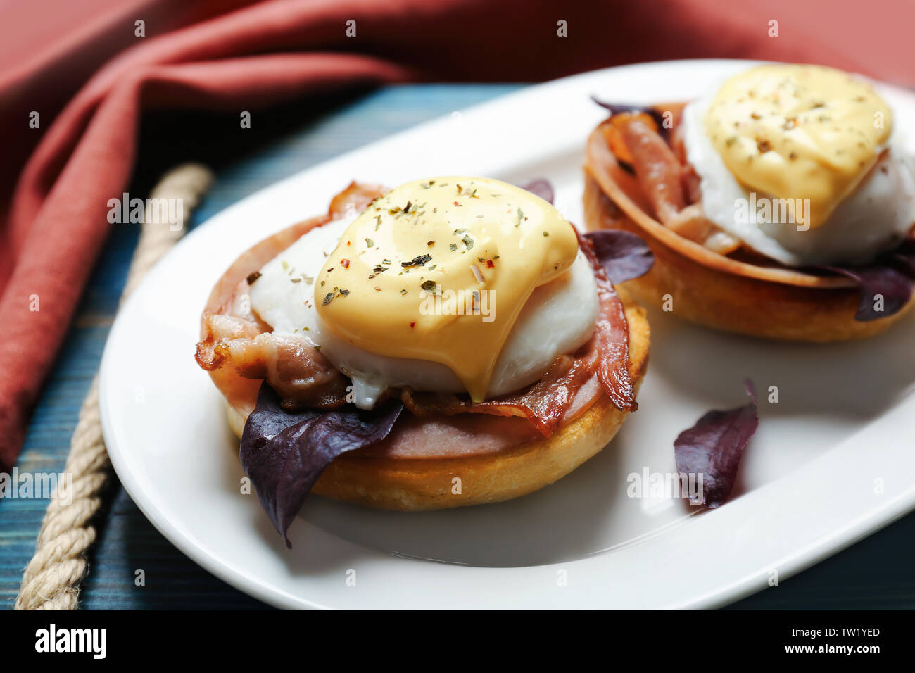 Tasty eggs Benedict on plate Stock Photo - Alamy