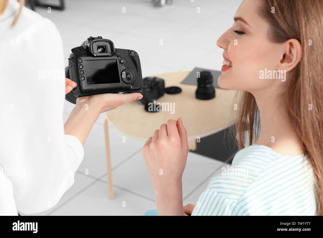 Female instructor showing camera display during photography classes ...