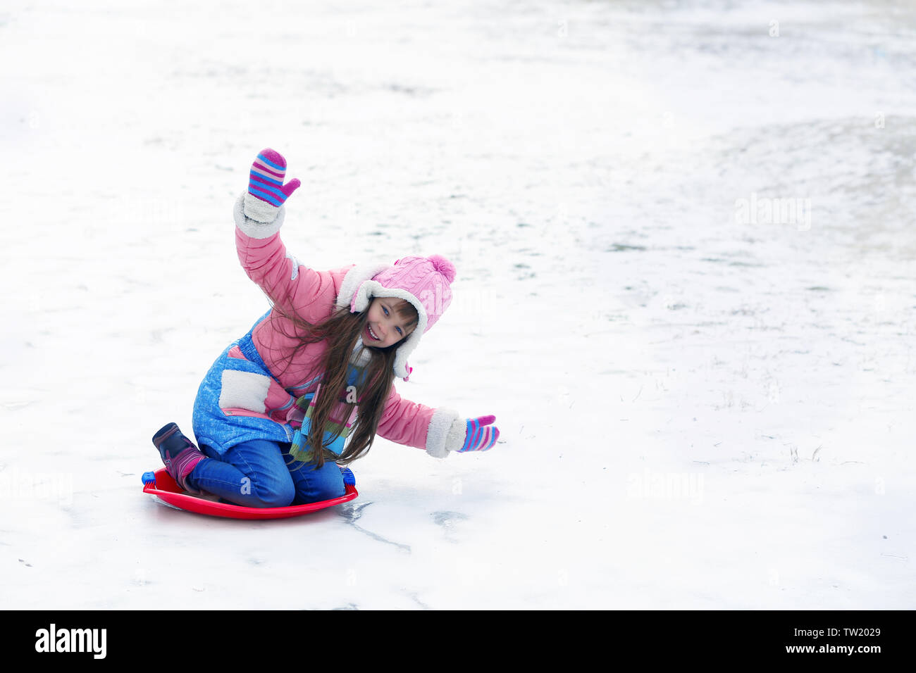 Girl on sled having fun hi-res stock photography and images - Alamy
