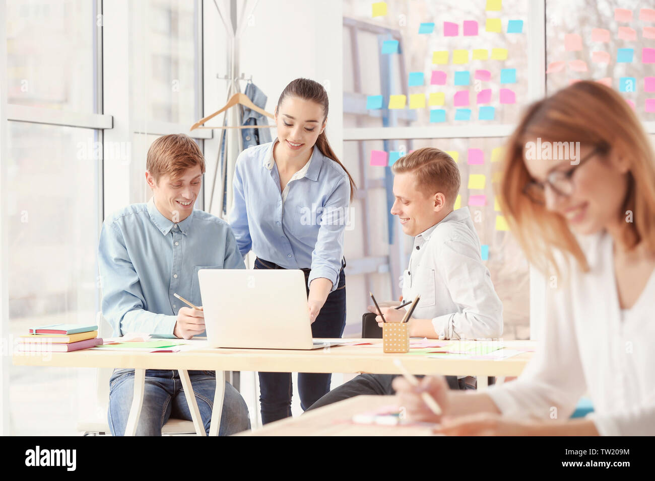 Young people working in office Stock Photo - Alamy