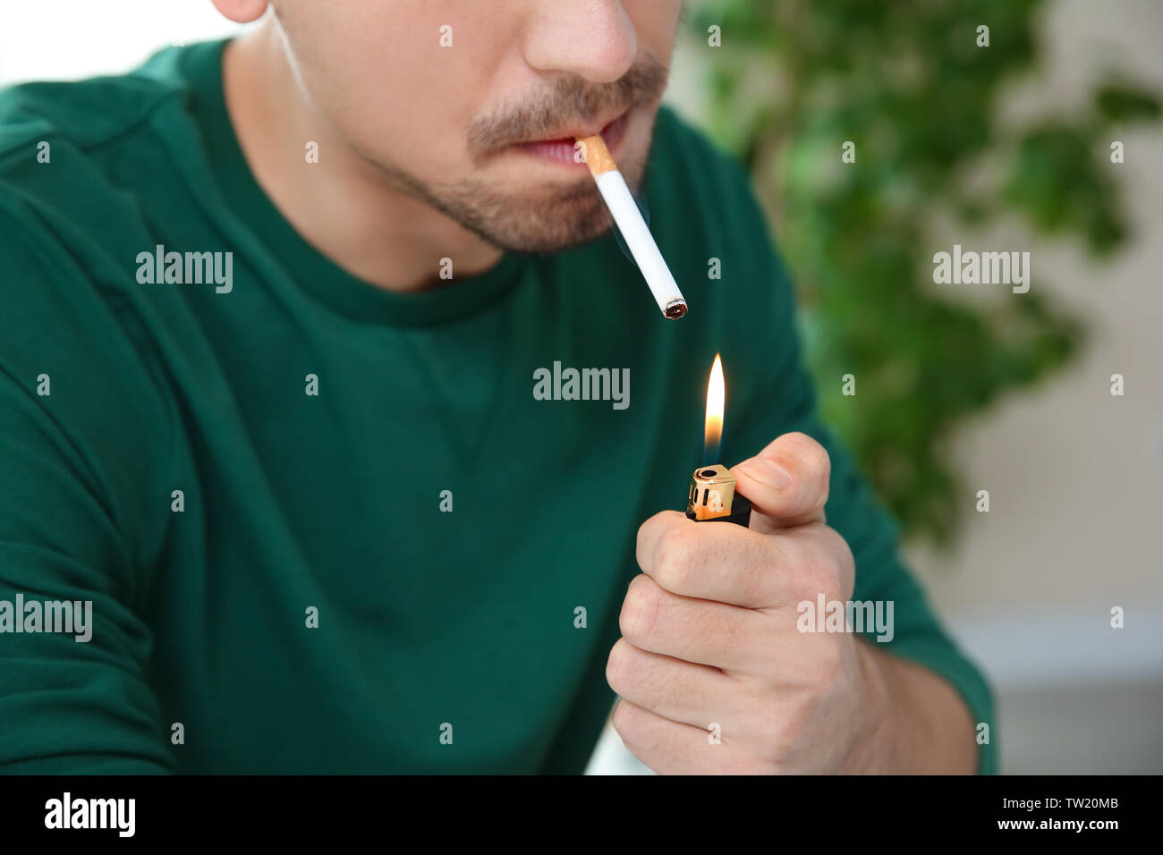 Young man lighting cigarette hi-res stock photography and images - Alamy