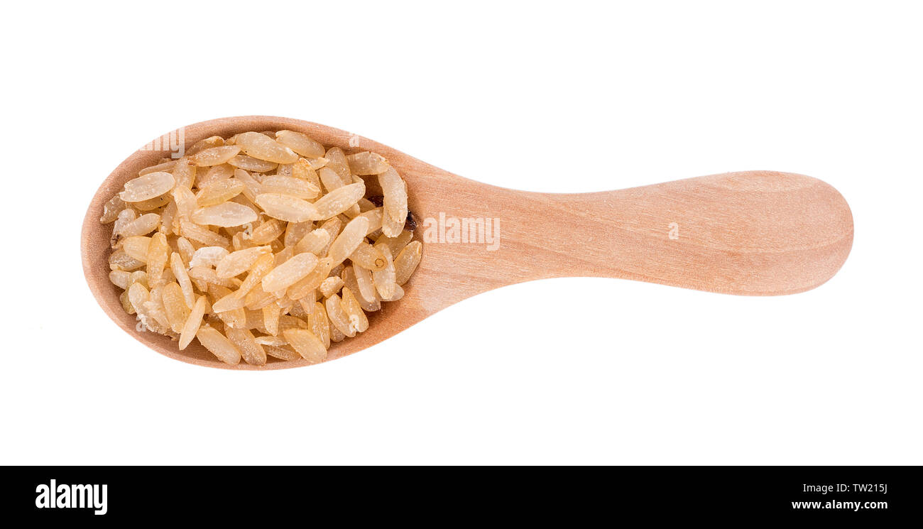 pounded unripe rice in wooden spoon on white background Stock Photo - Alamy