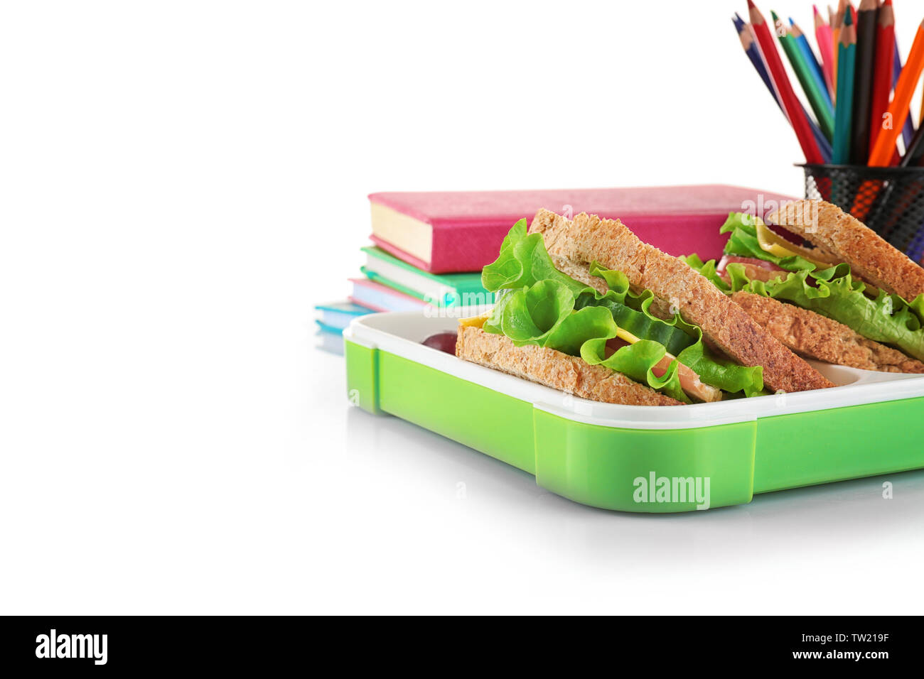 Lunch box with food and stationery on white background Stock Photo - Alamy