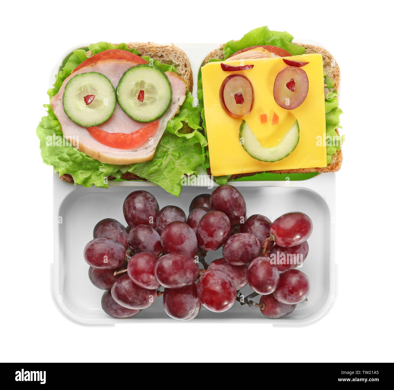 Lunch box with funny sandwiches and grape on white background Stock ...