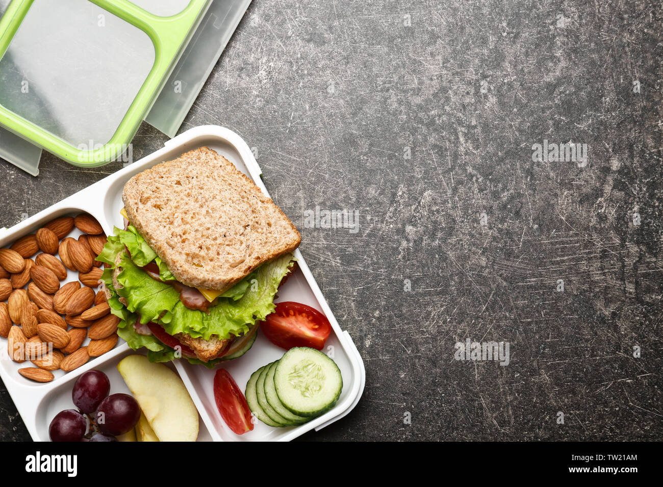 Lunch box with delicious food on grunge background Stock Photo - Alamy