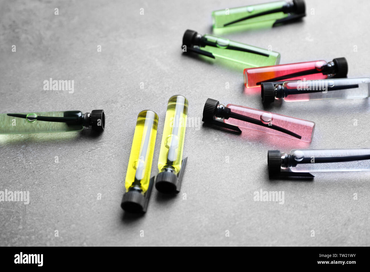 Perfume samples on gray background Stock Photo - Alamy