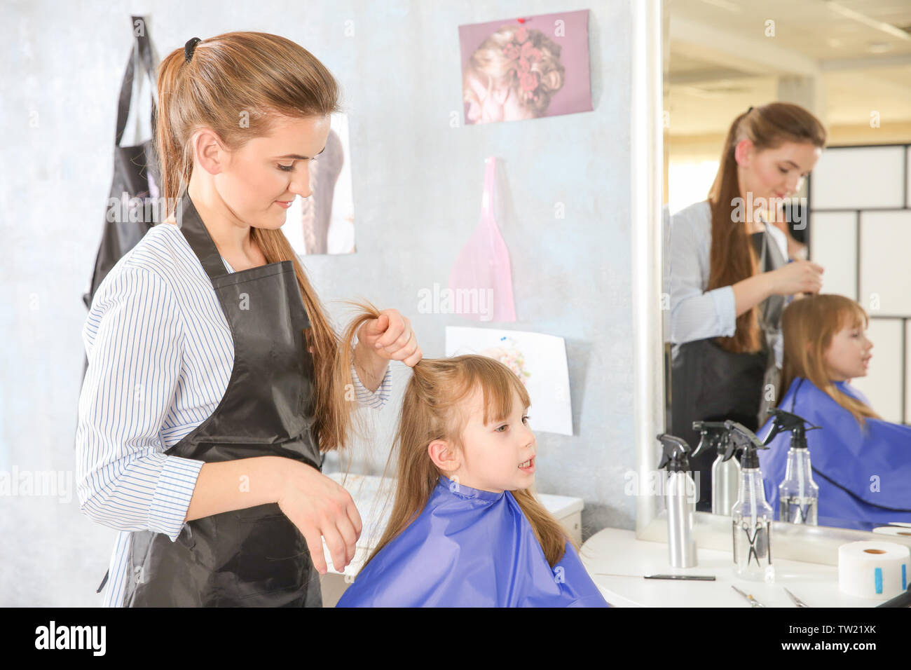 Cute little girl in hairdressing salon Stock Photo - Alamy