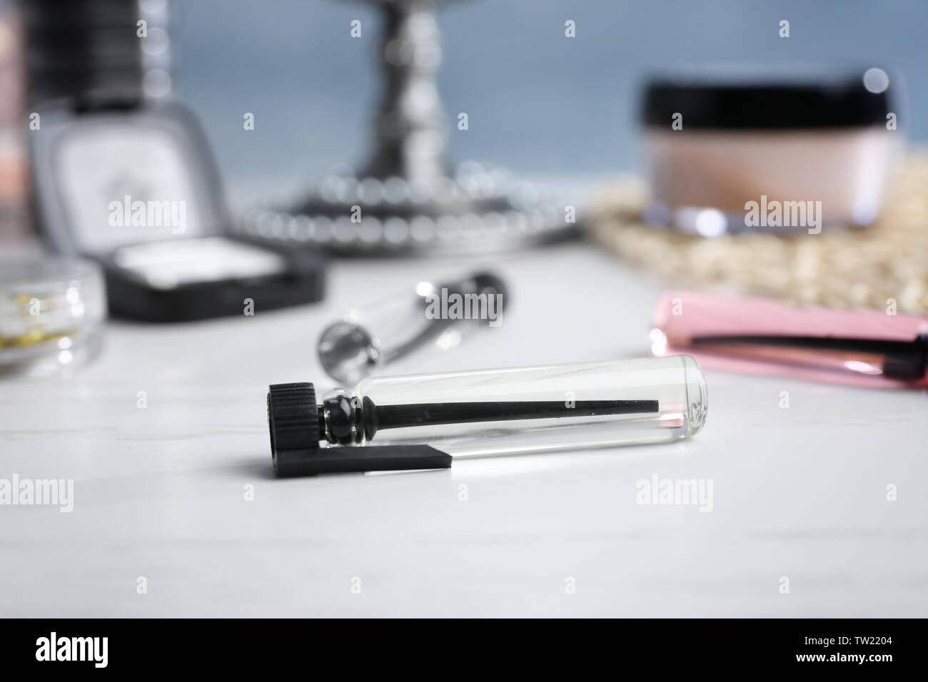 Perfume sample on blurred background Stock Photo - Alamy