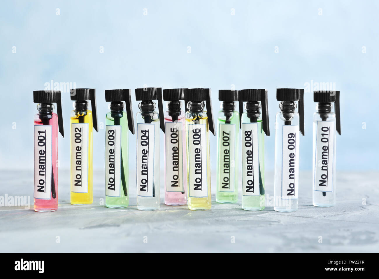 Different perfume samples on light background Stock Photo - Alamy