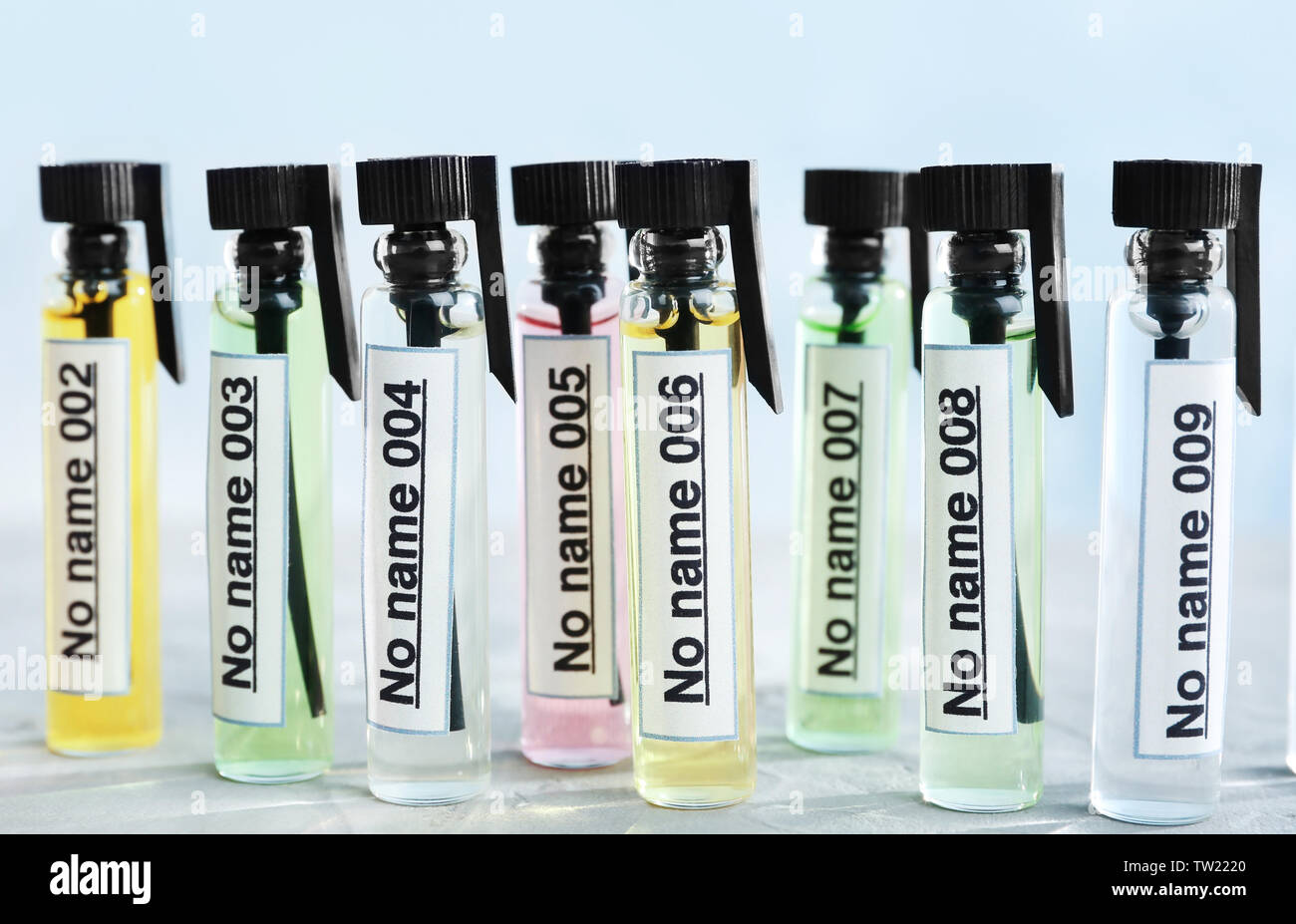 Different perfume samples on light background Stock Photo - Alamy