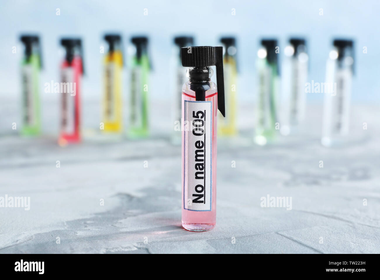 Perfume sample on blurred background Stock Photo - Alamy
