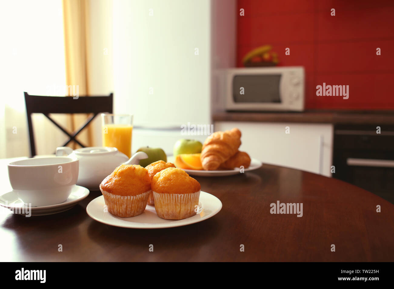 Delicious food on wooden round table in kitchen Stock Photo - Alamy