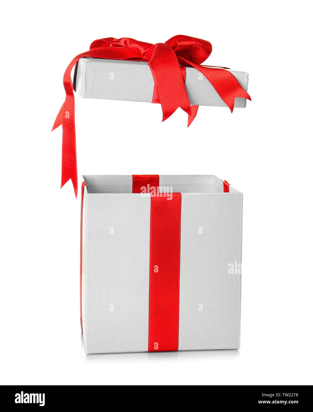 Open gift box with red ribbon on white background Stock Photo - Alamy