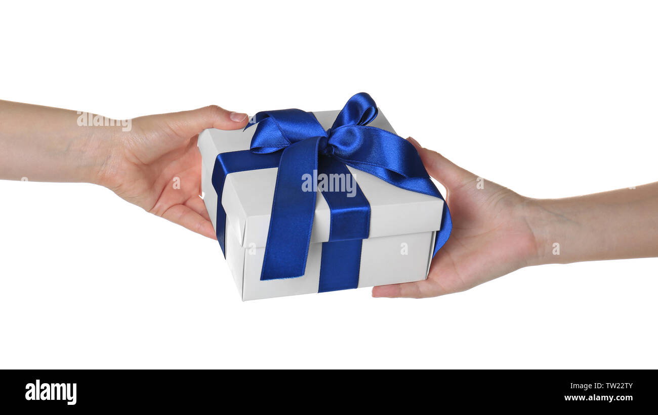 Hands giving and receiving gift box on white background Stock Photo - Alamy